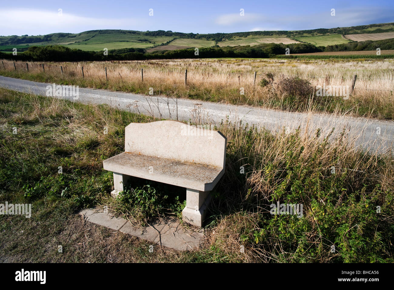 footpath with concrete bench the dorset downs behind at kimmeridge ...