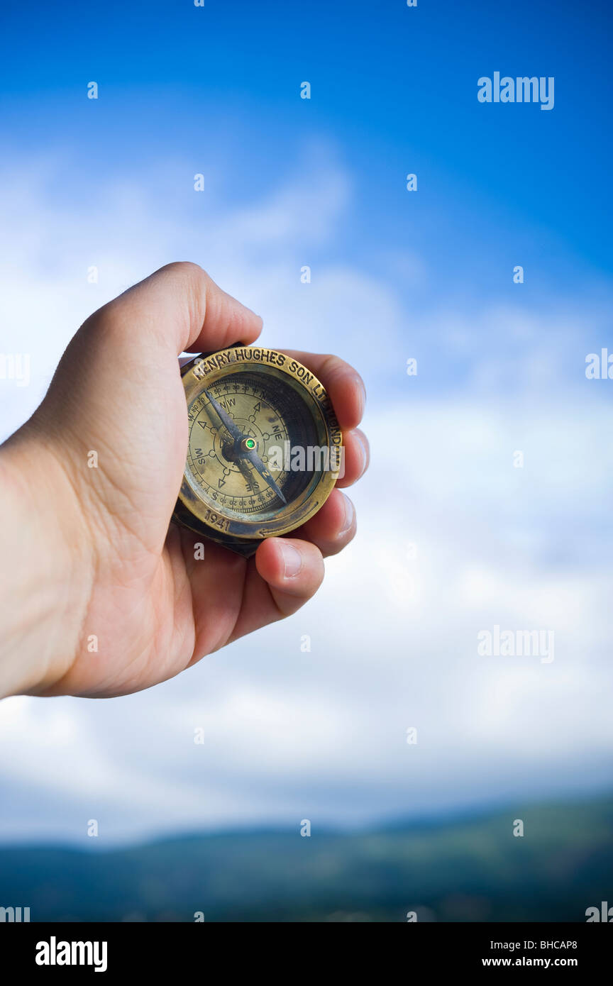 Hand holding compass Stock Photo - Alamy