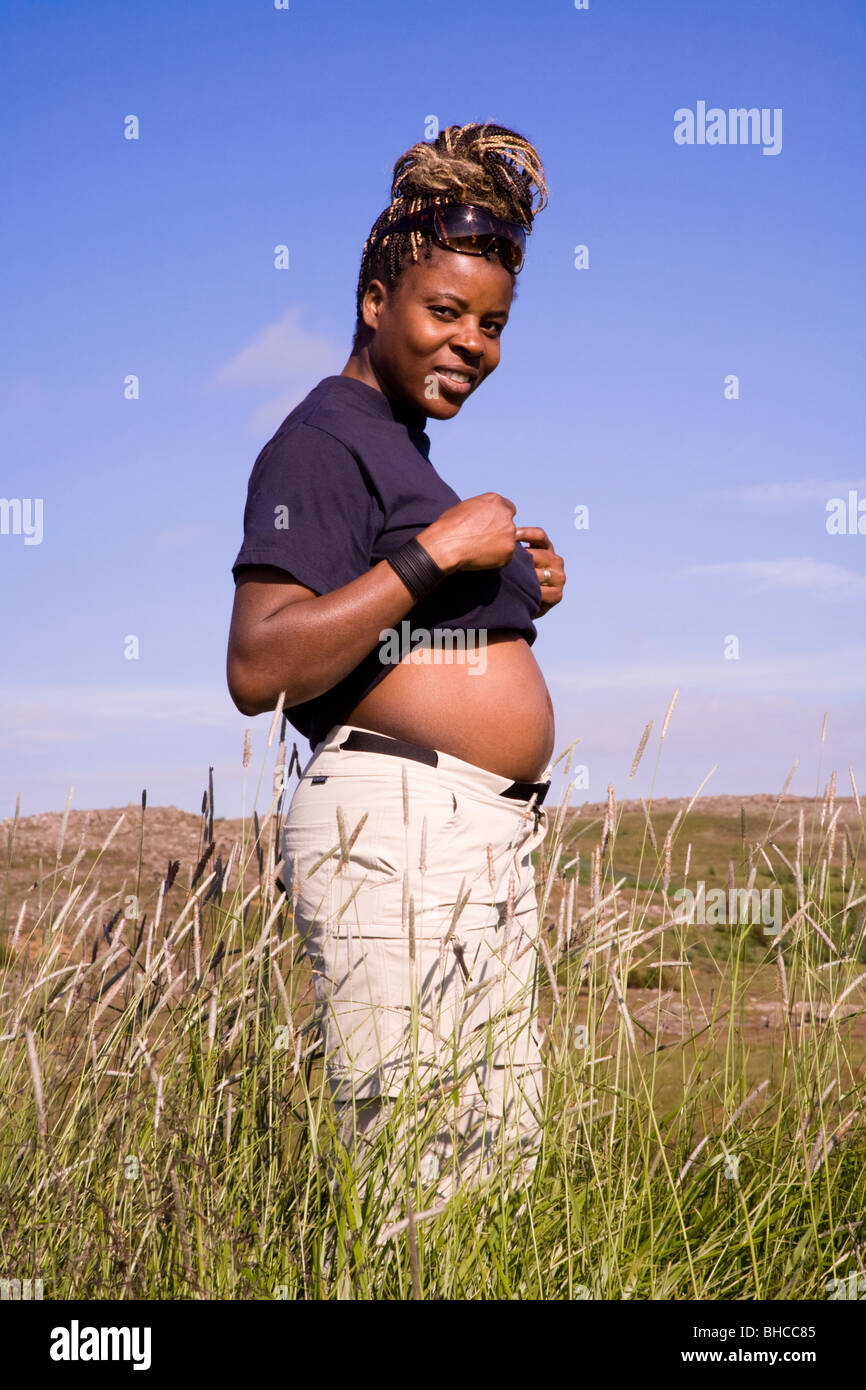 Woman four months pregnant Stock Photo - Alamy