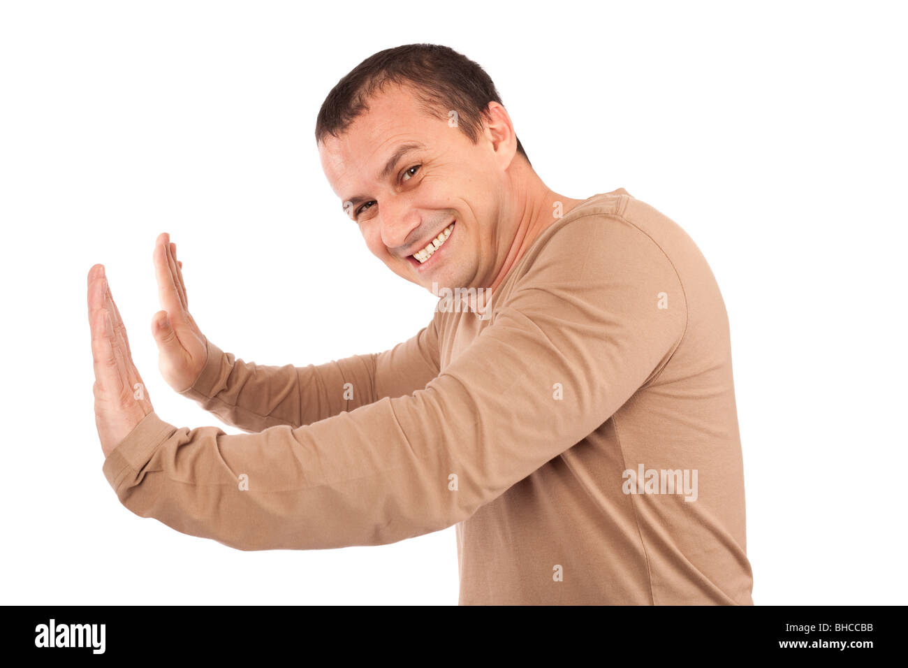 Man pushing with hands to the side of the image Stock Photo - Alamy