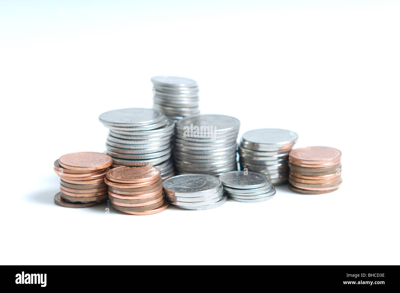 Stacks of copper and silver coins varying in sizes and denominations ...