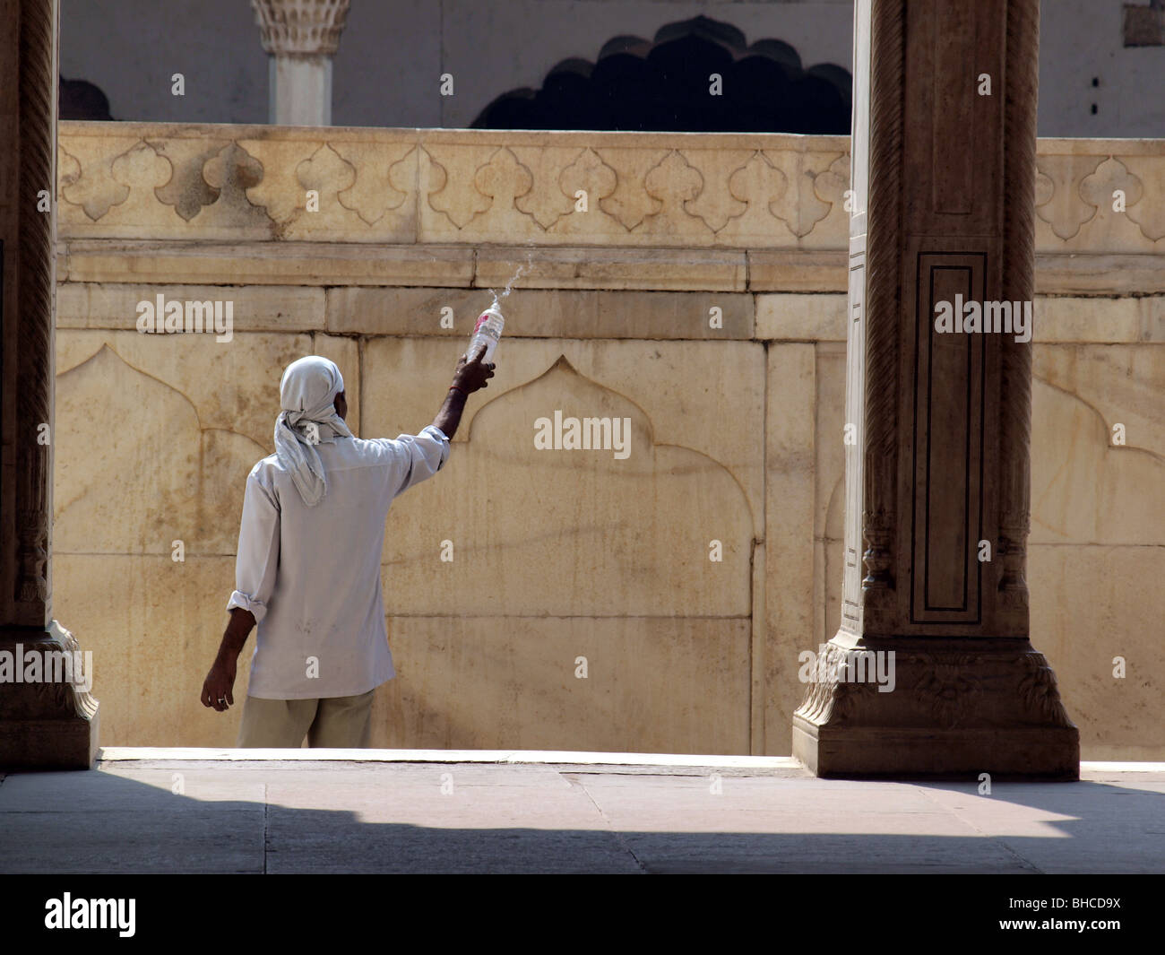 Mosque Cleaner throws water at walls of the fort at Agra Stock Photo ...