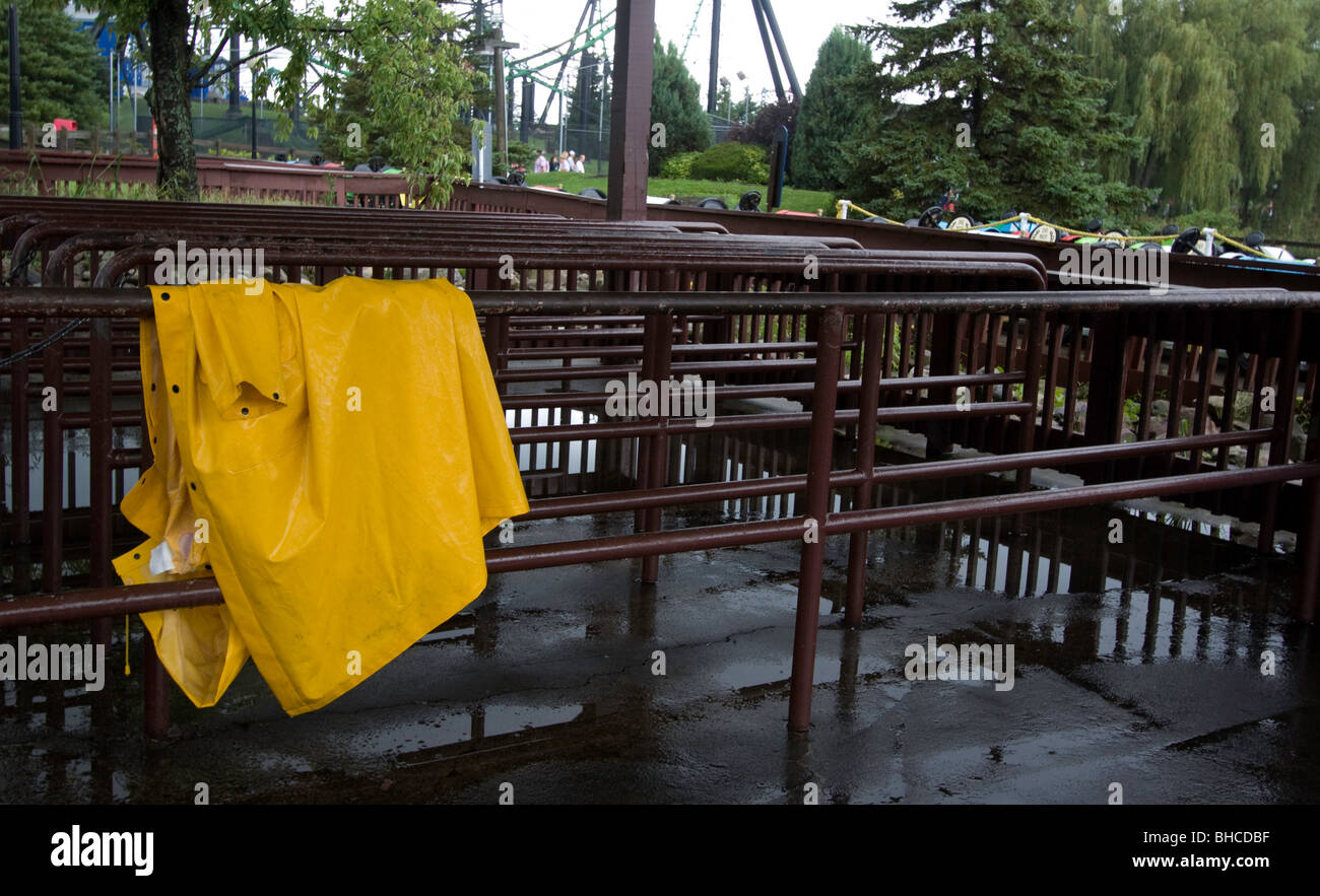 yellow raincoat at empty amusement park turnstiles Stock Photo - Alamy