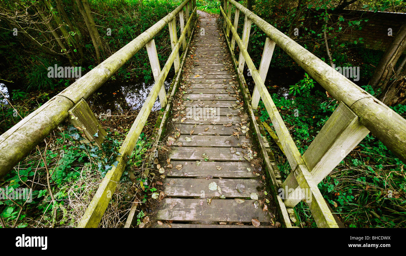 a wooden footbridge over a stream Stock Photo - Alamy