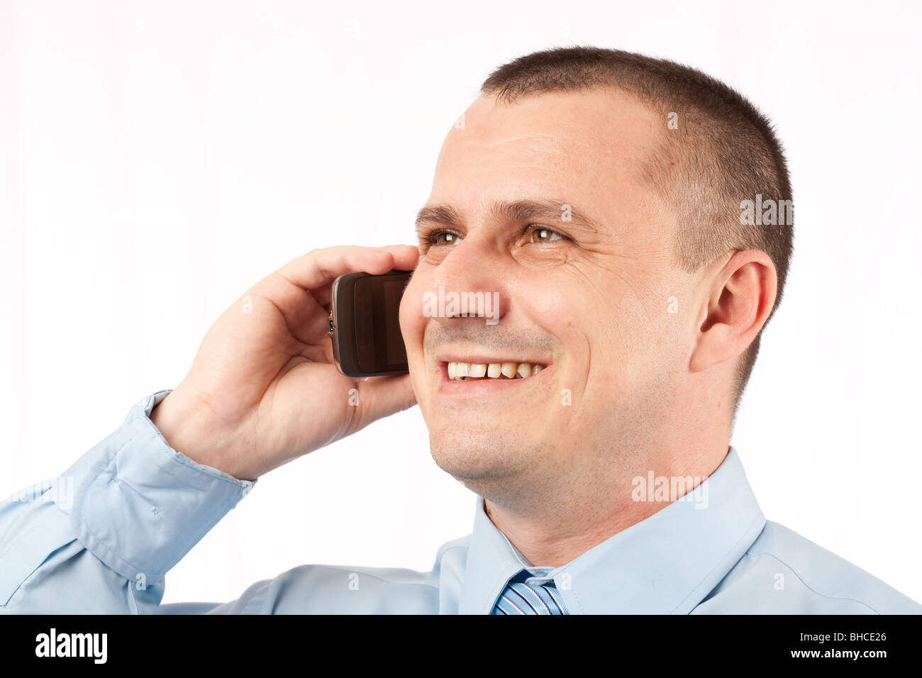 Portrait of a young businessman speaking on mobile phone, isolated on ...