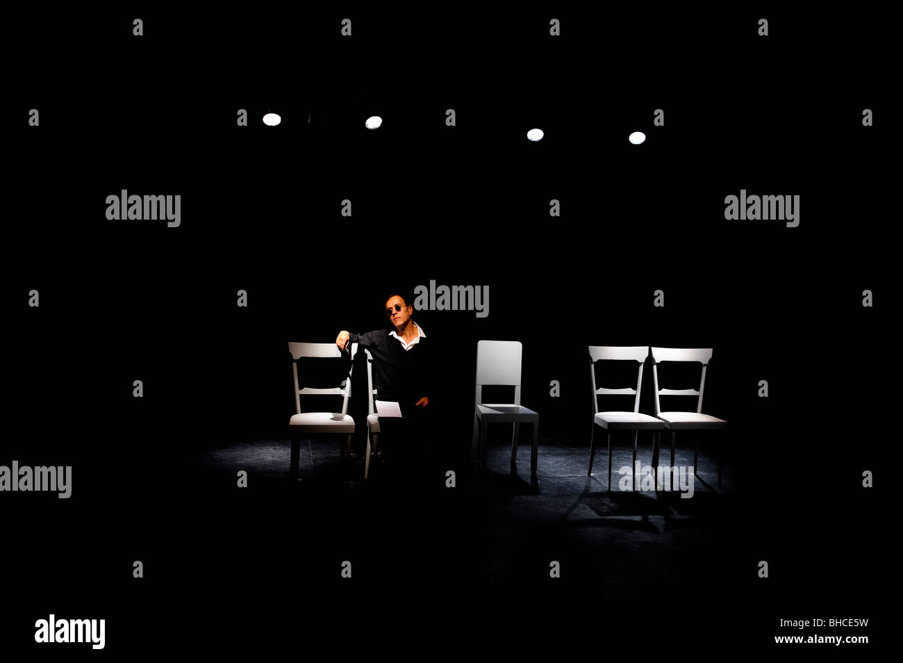 Lonely man sitting on stage during theatrical performance Stock Photo ...
