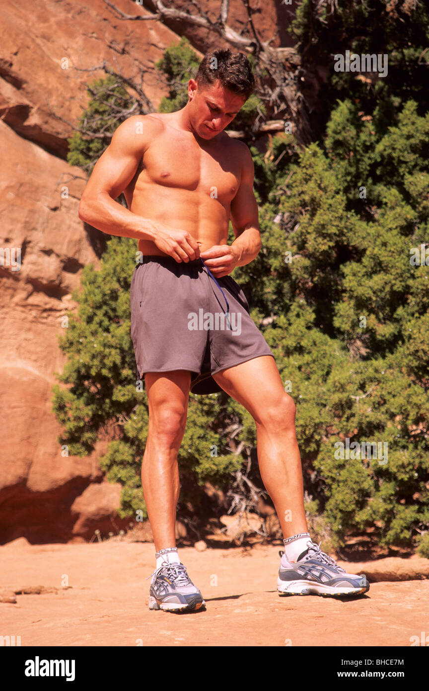 Runner adjusting shorts Stock Photo - Alamy