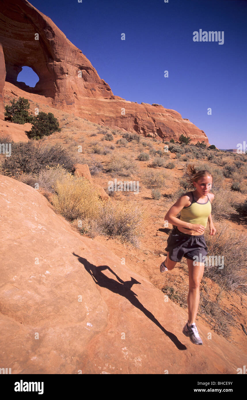 Woman running in the desert Stock Photo - Alamy