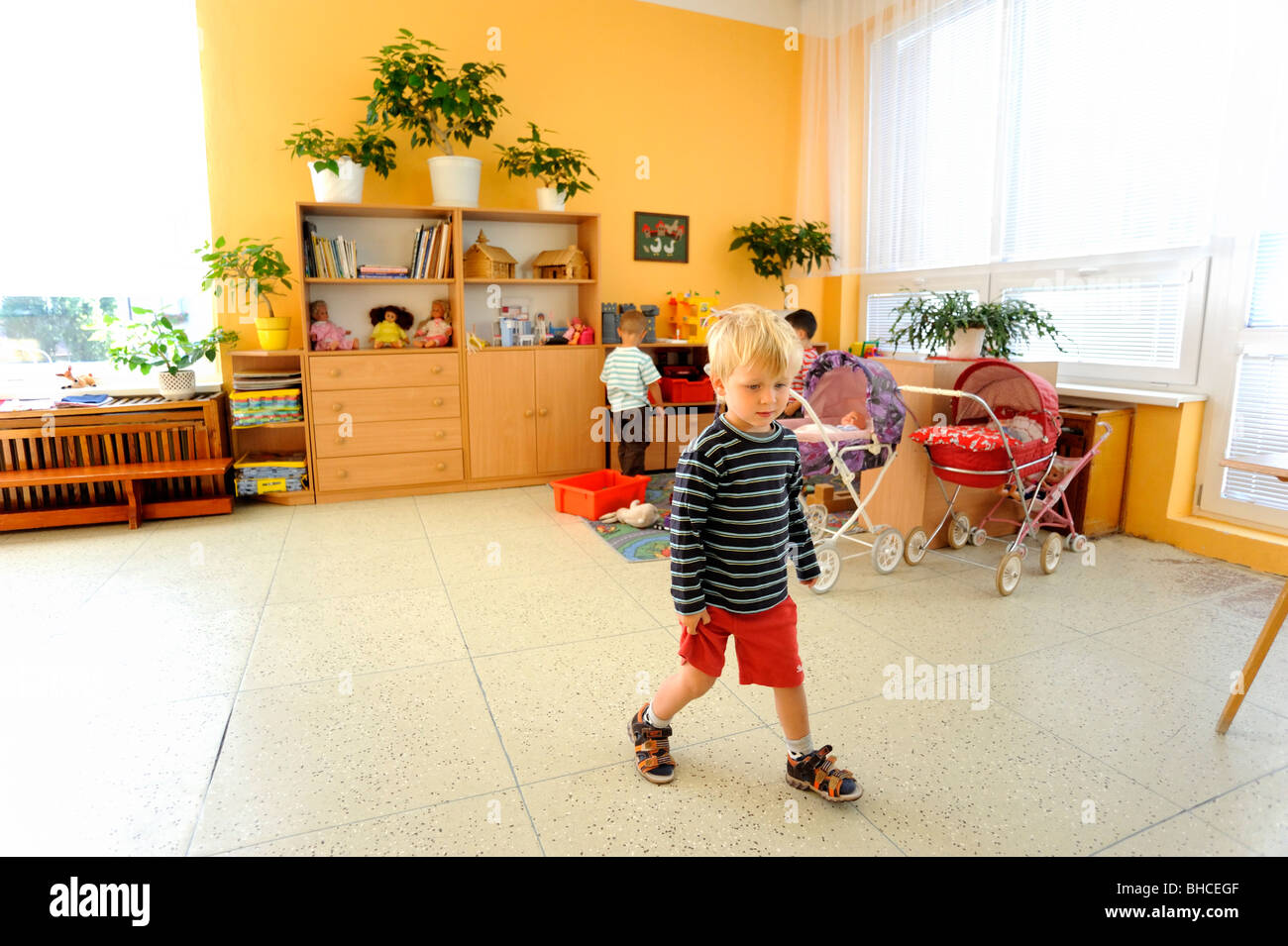 Preschool children playing in class with toys Stock Photo - Alamy