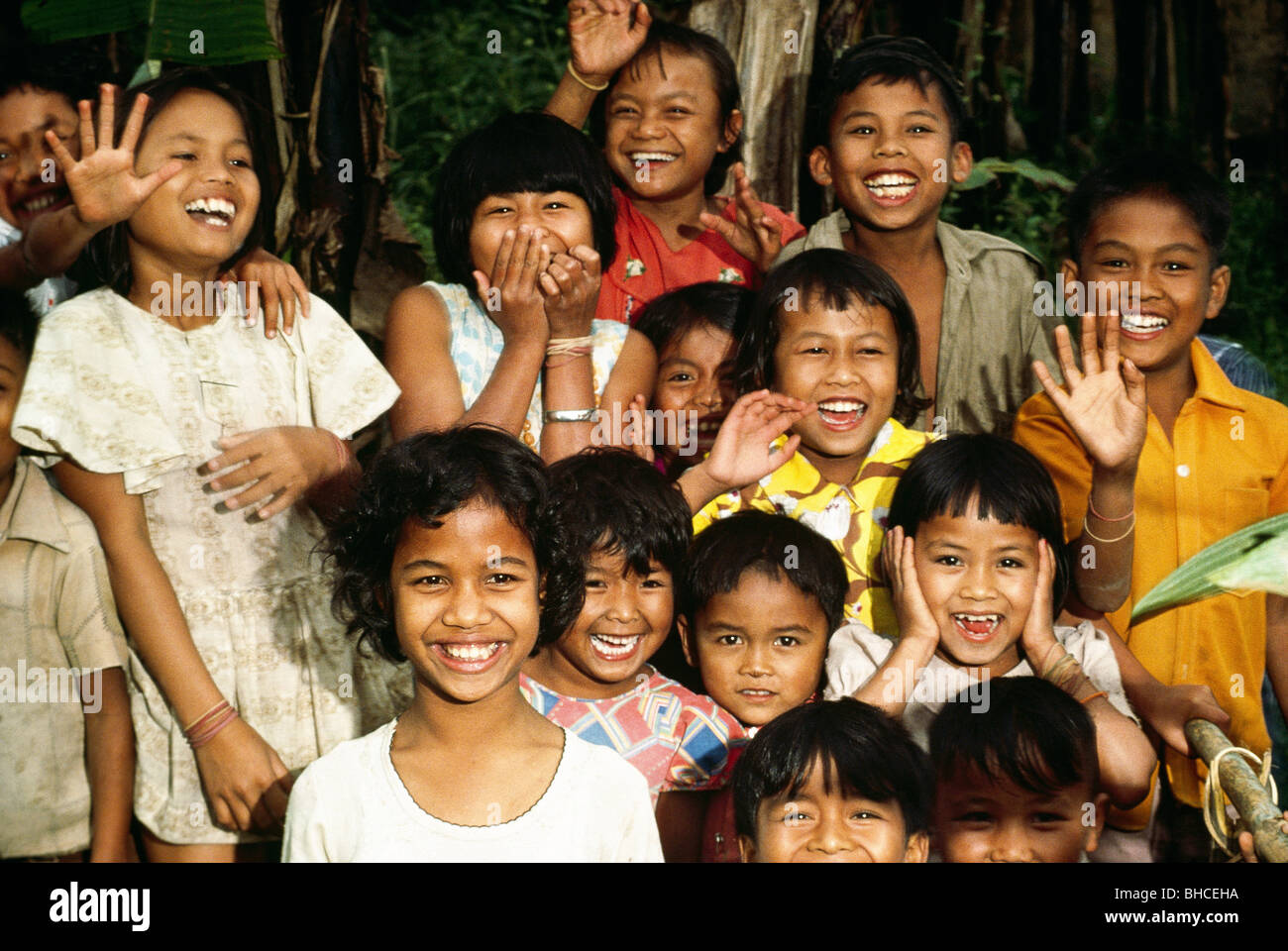 Children waving and smiling Stock Photo - Alamy