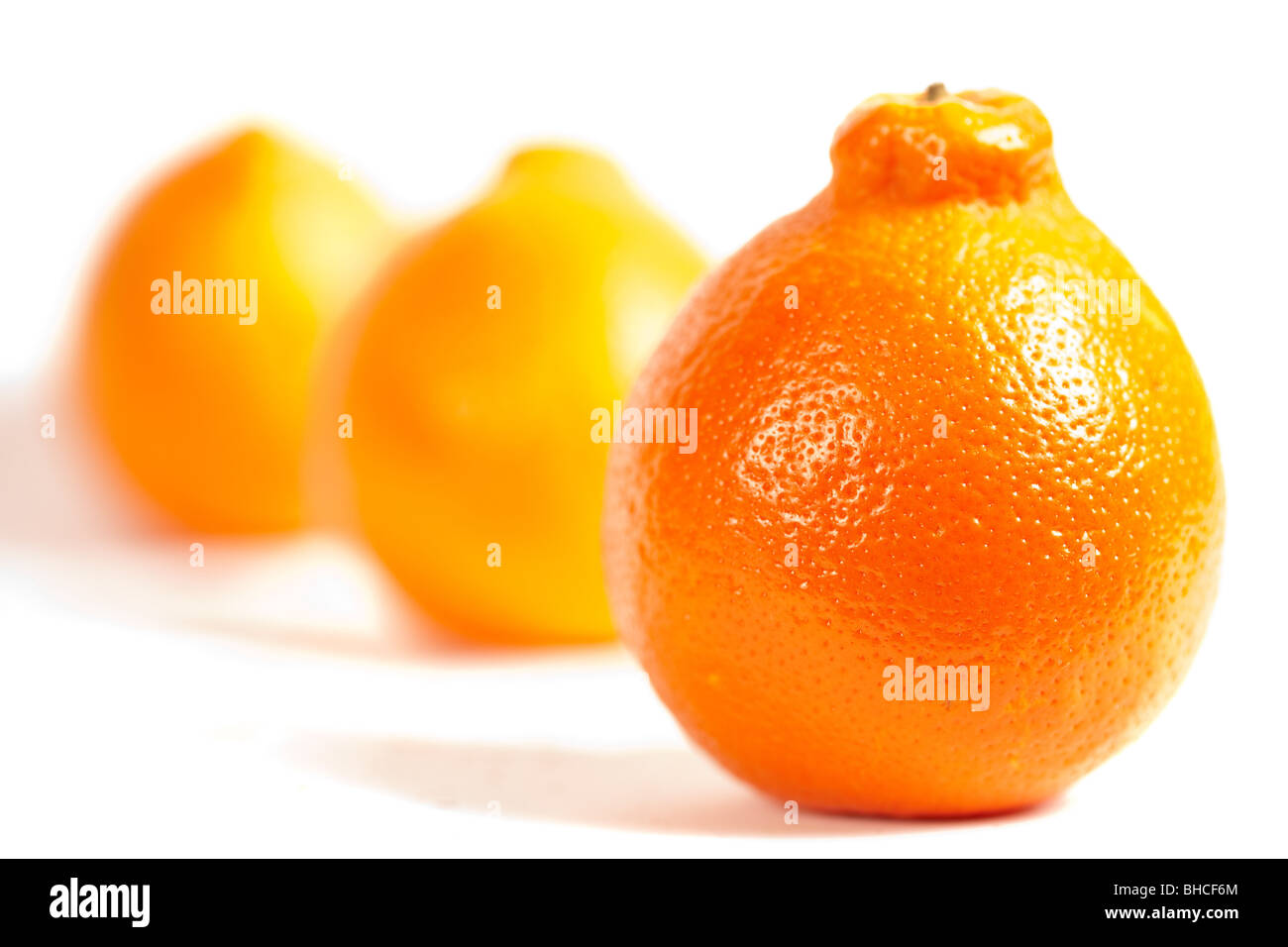 Three oranges isolated on white, shallow depth of field Stock Photo - Alamy