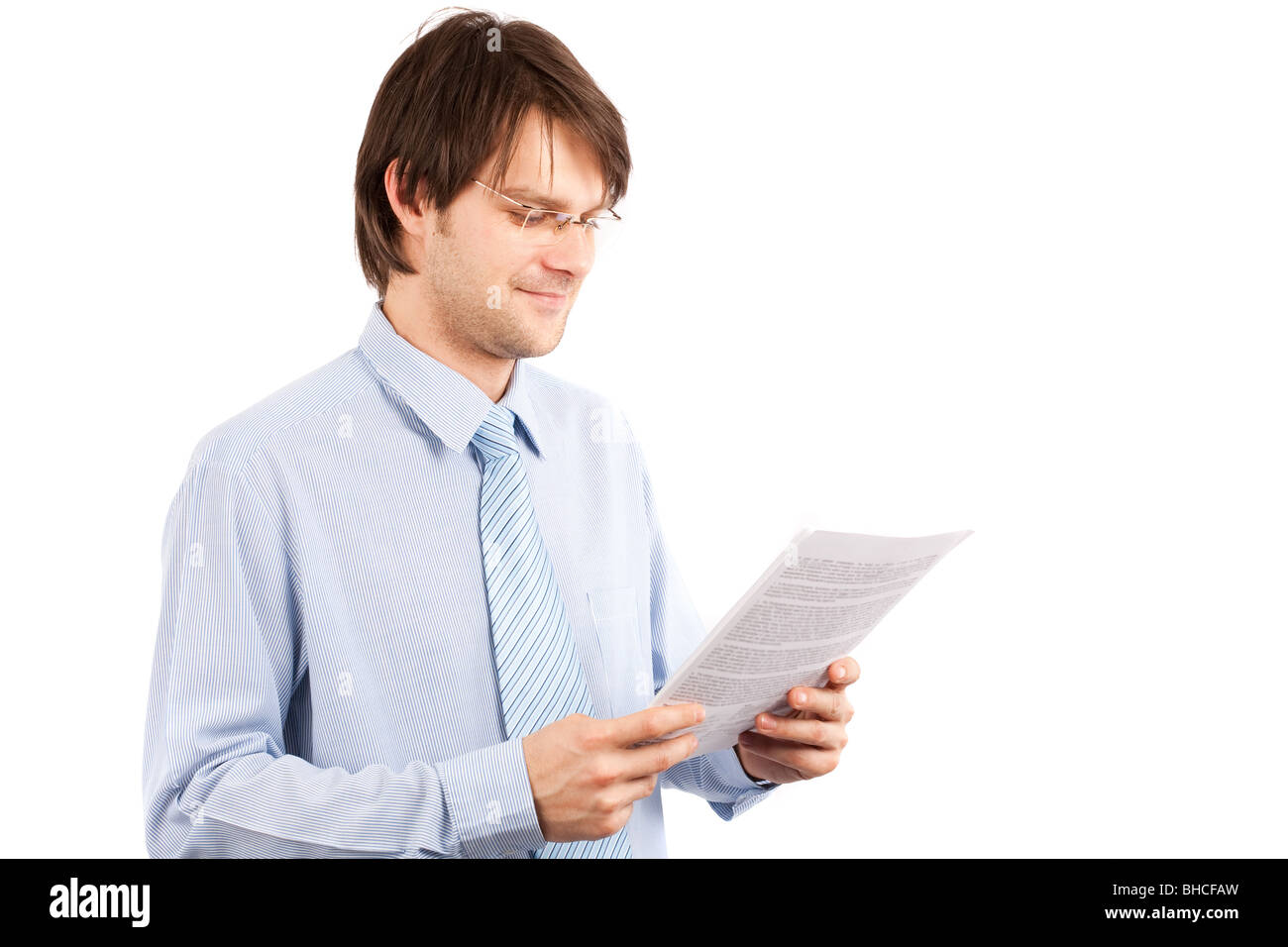 Portrait of a young businessman reading a report, isolated on white ...