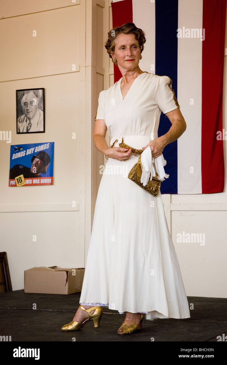 Attractive woman in 1940s clothing posing in front of flag during a ...