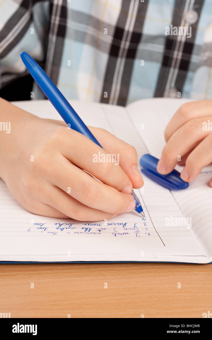 Close up of a hand of a pupil writing homework or examination Stock ...