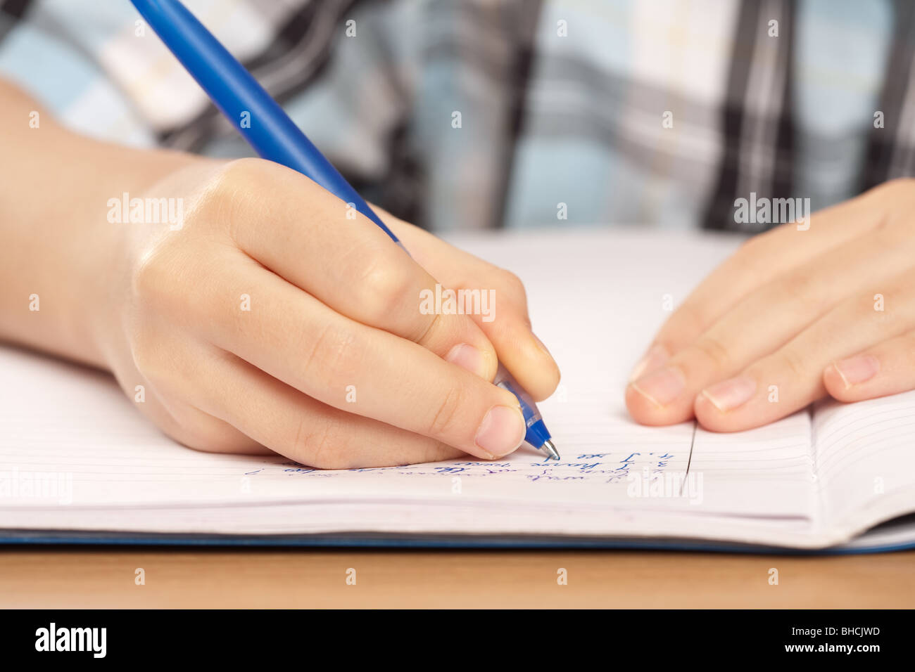 Close up of a hand of a pupil writing homework or examination Stock ...