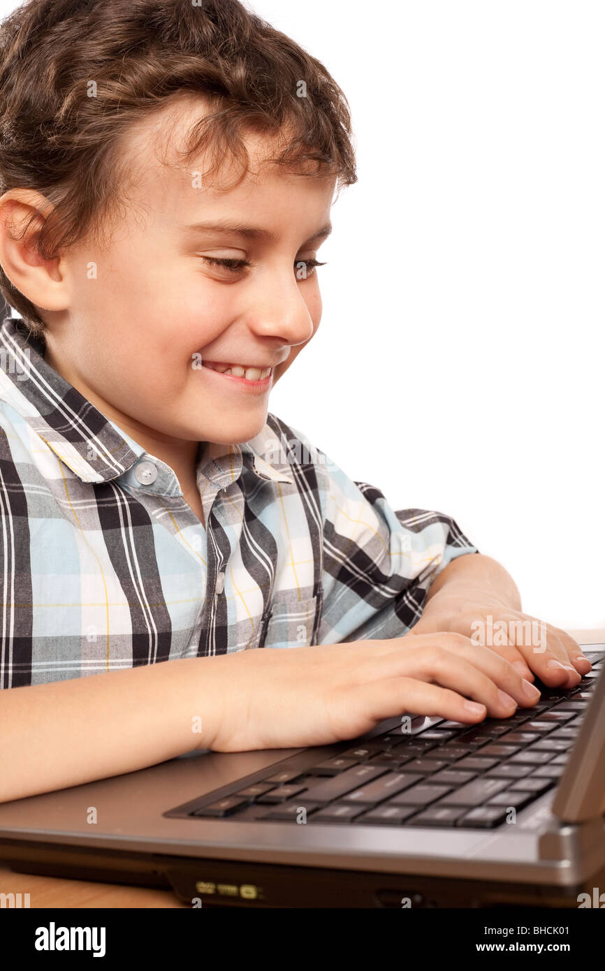 Cute boy sitting computer desk Cut Out Stock Images & Pictures - Alamy