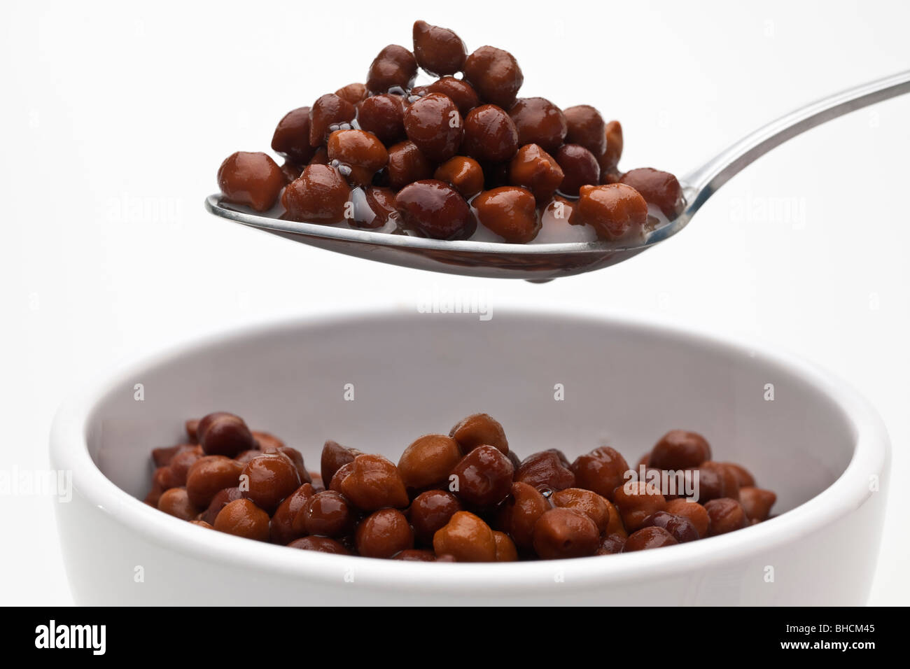 Spoonful of Kala Chana beans in water lifted on a spoon Stock Photo - Alamy