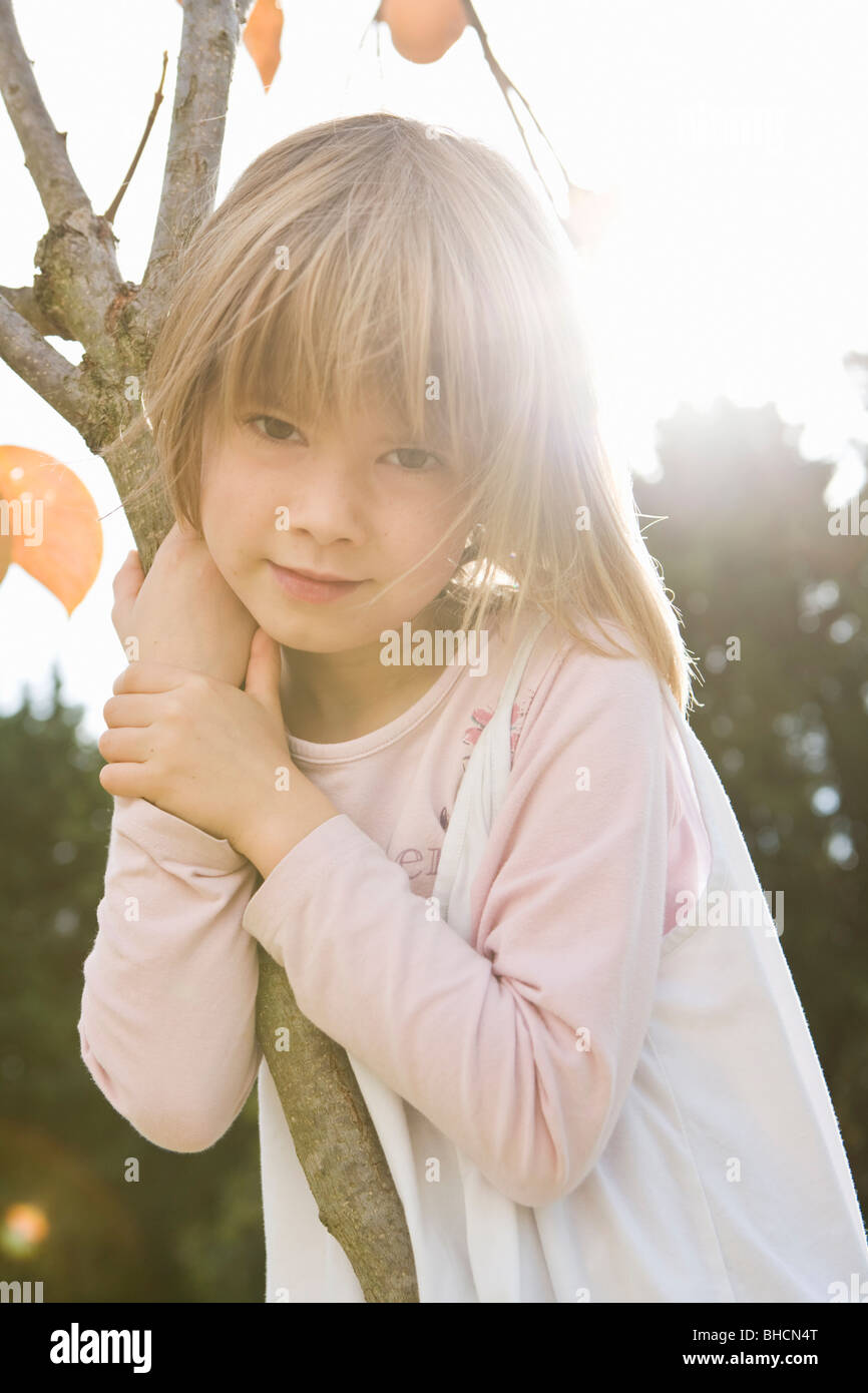Girl hugging tree portrait Stock Photo - Alamy
