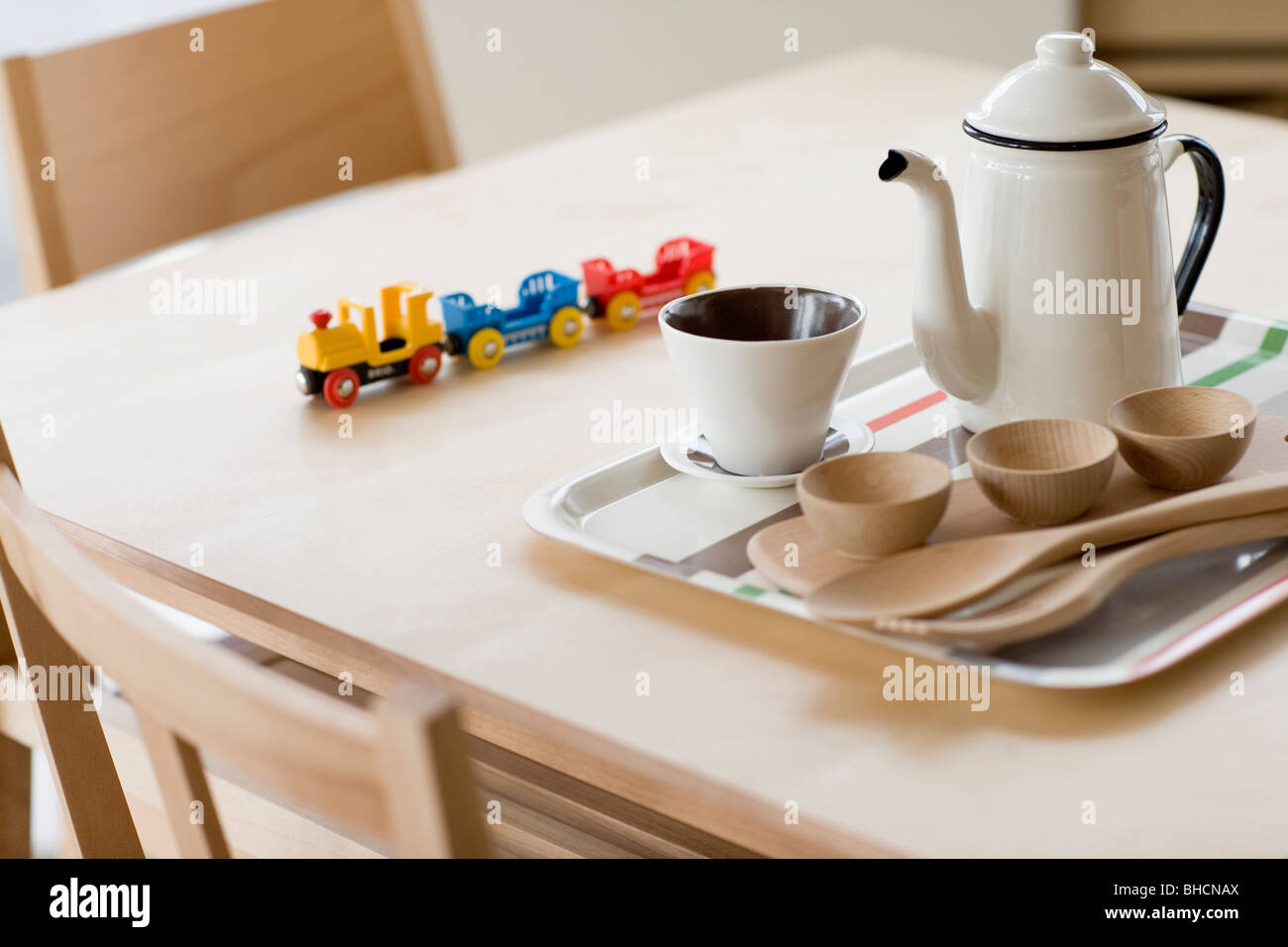 Tea cup , Teapot, wooden bowls and miniature train Stock Photo - Alamy