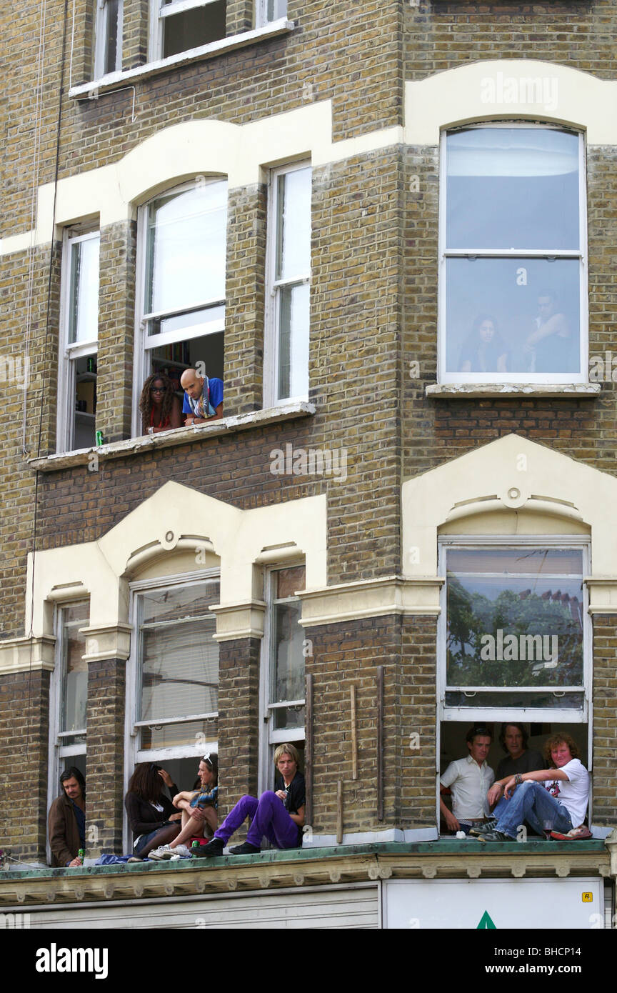People at the windows looking at street. London Stock Photo - Alamy