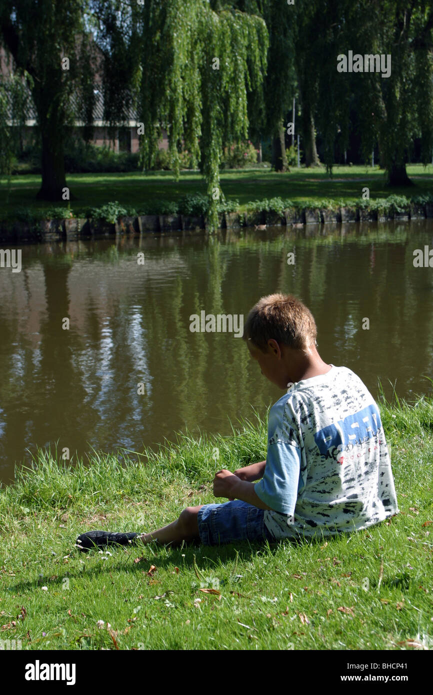 Sad child sitting from behind hi-res stock photography and images - Alamy