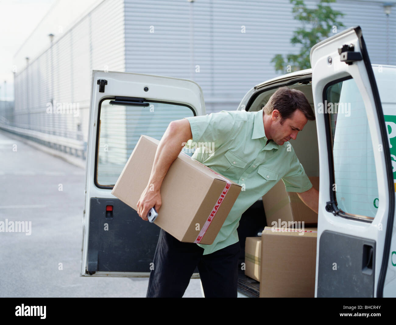 A courier delivers parcels Stock Photo - Alamy