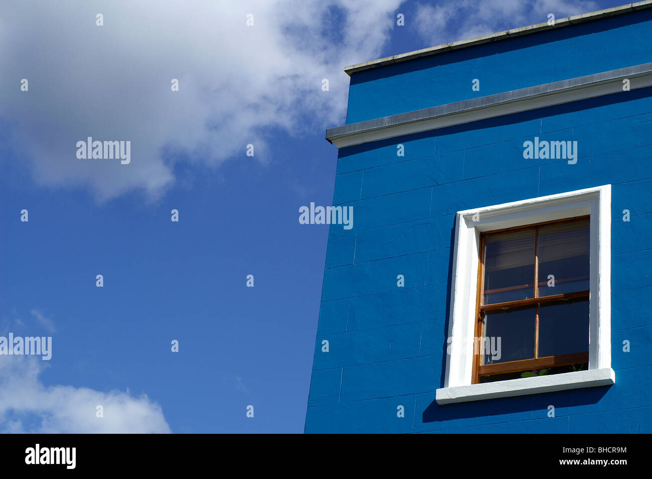 Blue house with white window Stock Photo - Alamy