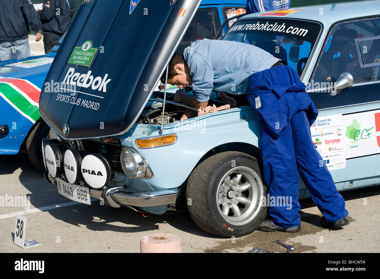 Mechanic working on a 1969 BMW 2002 rally car in the pits Stock Photo ...