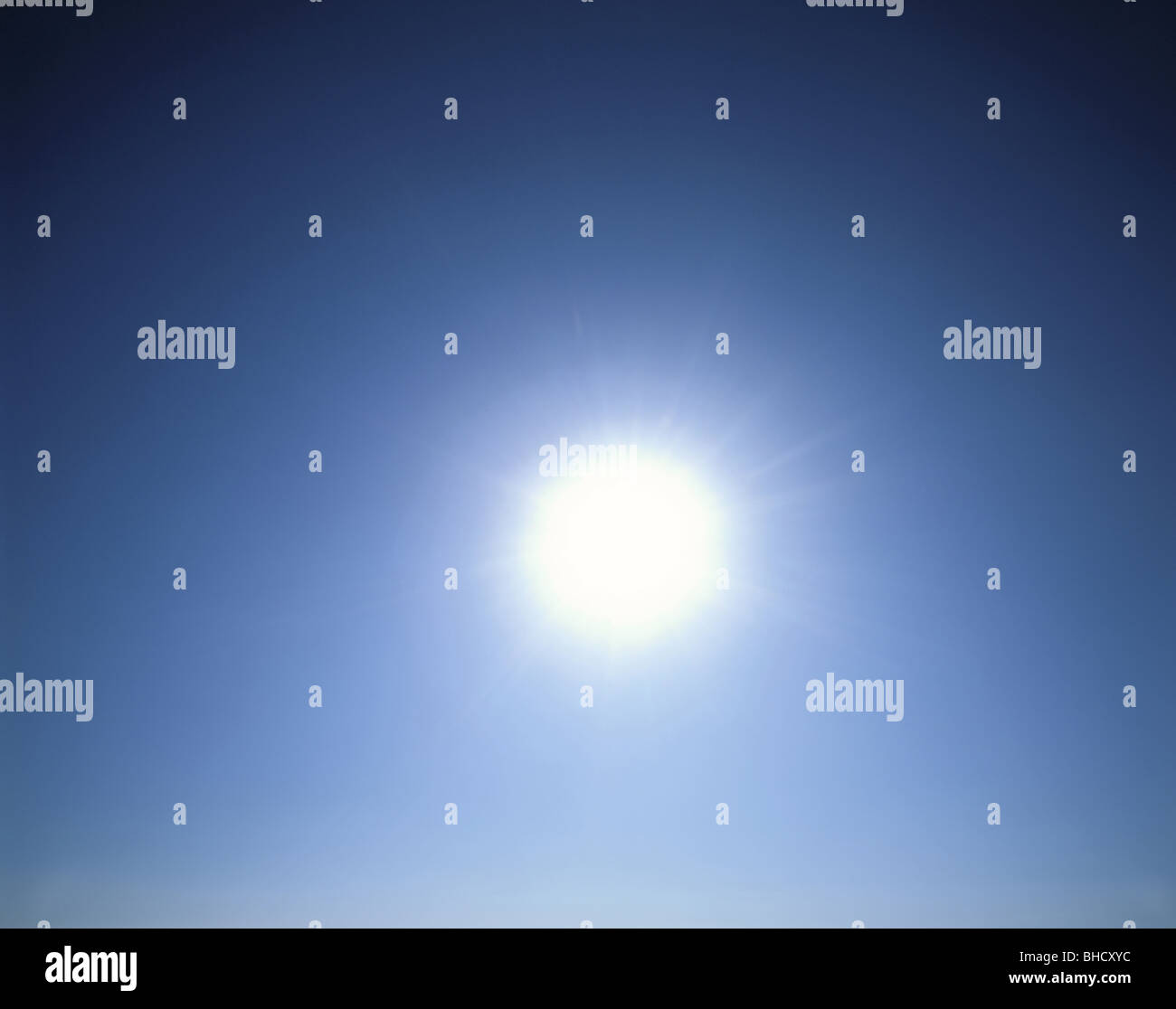 Sun in blue sky Stock Photo - Alamy
