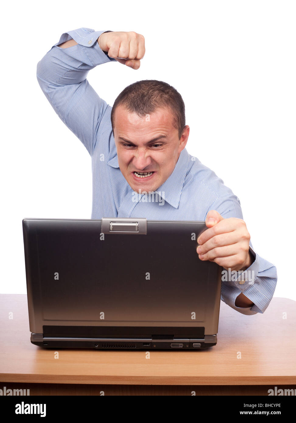 Angry businessman at laptop isolated on white Stock Photo - Alamy