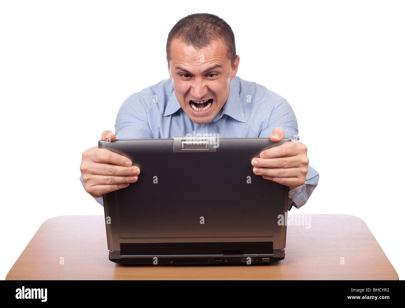 Angry businessman at laptop isolated on white Stock Photo - Alamy