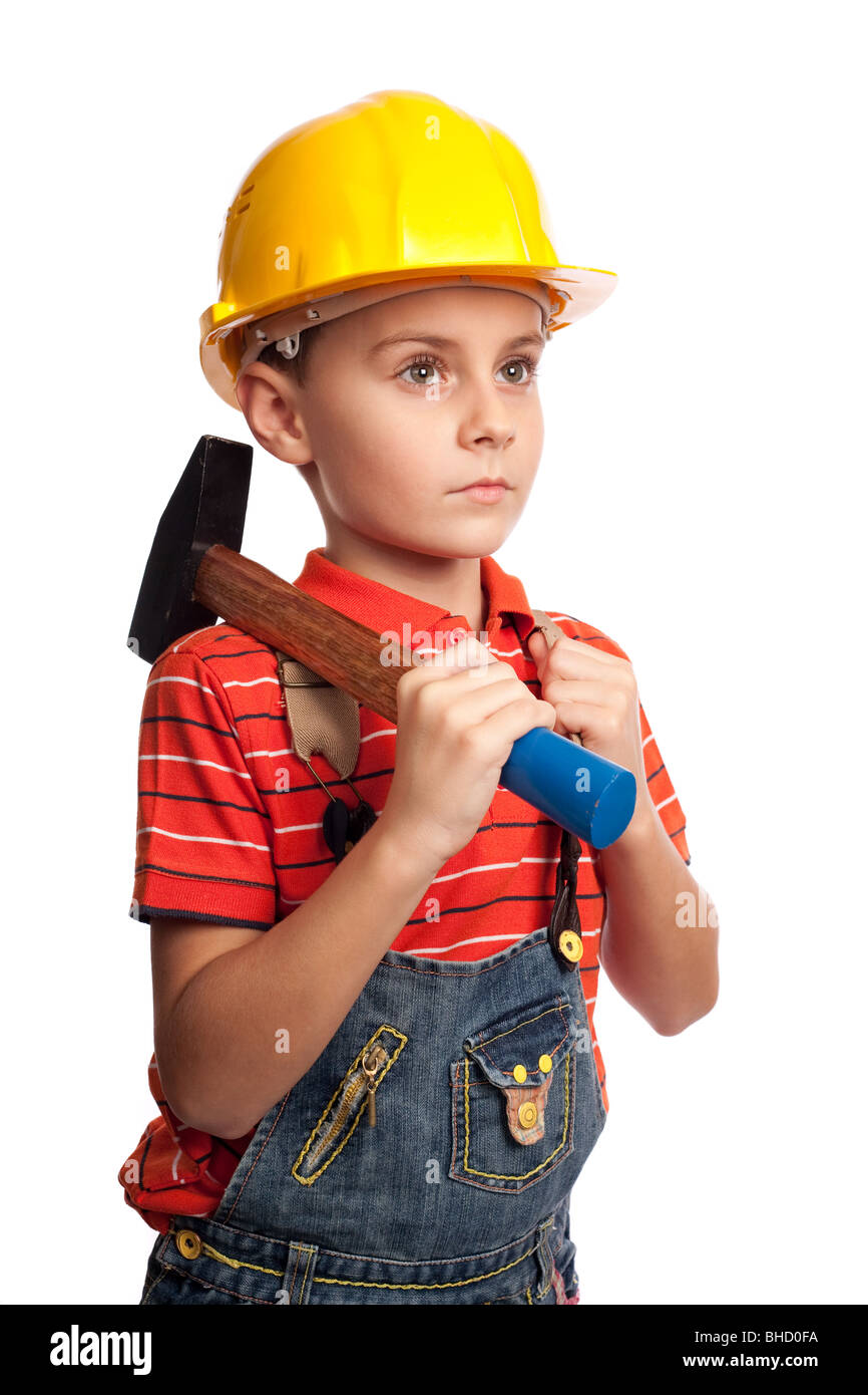 Cute kid as a construction worker, carrying a big hammer on the ...
