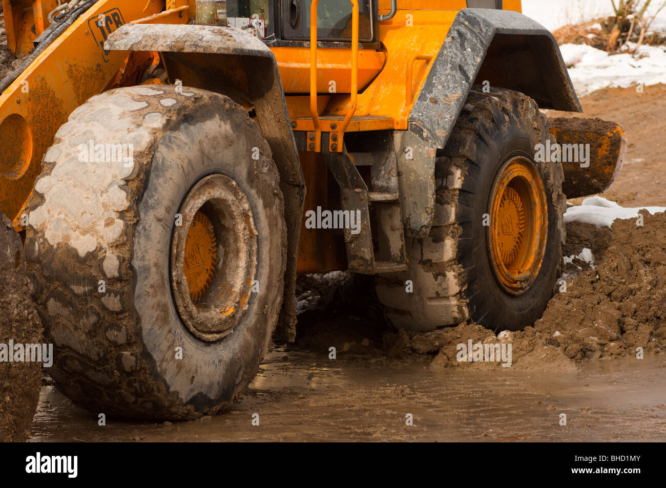 Bulldozer deep in mud and snow Stock Photo - Alamy
