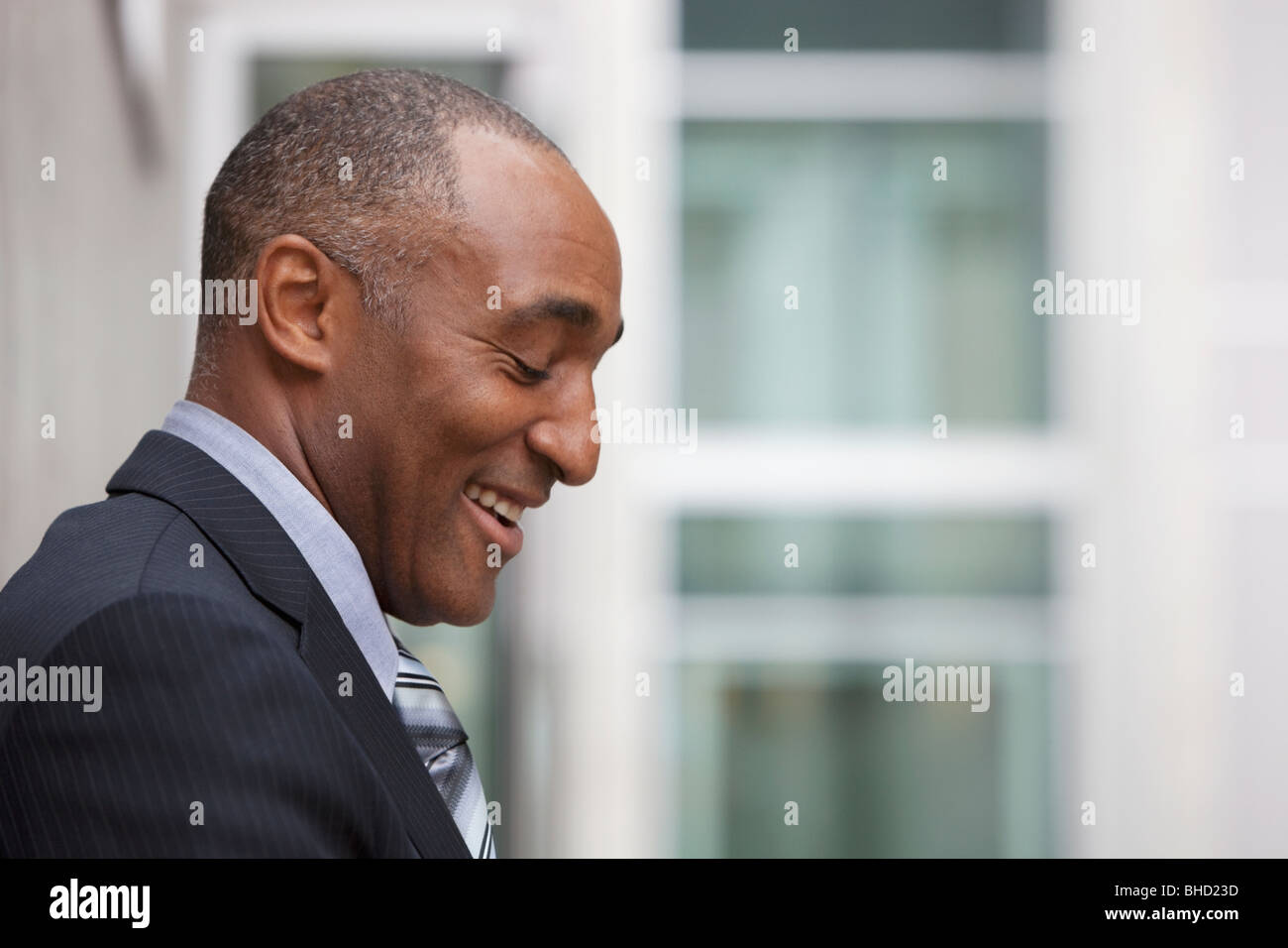 Mixed race businessman laughing Stock Photo - Alamy