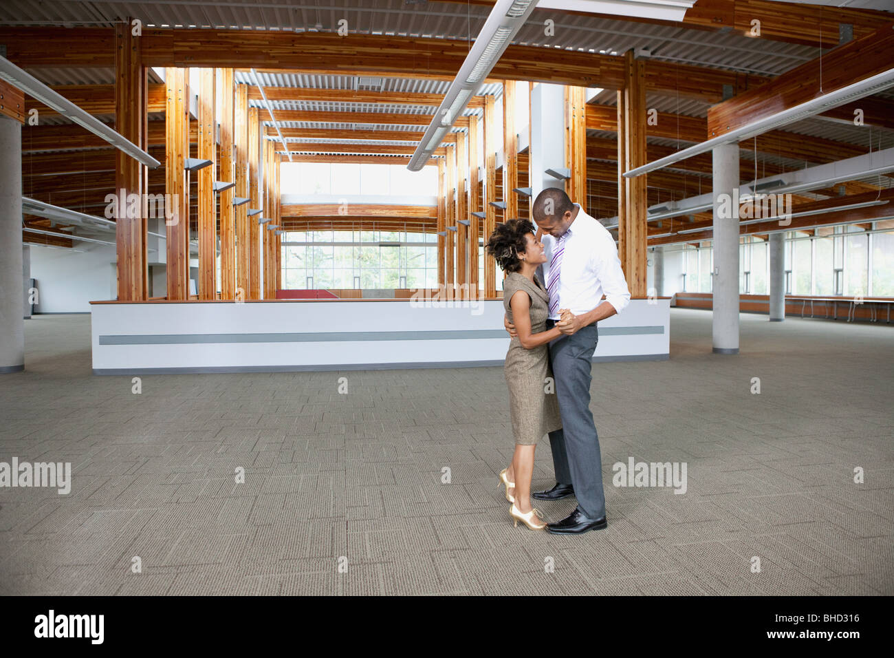 Couple dancing in empty office space Stock Photo - Alamy