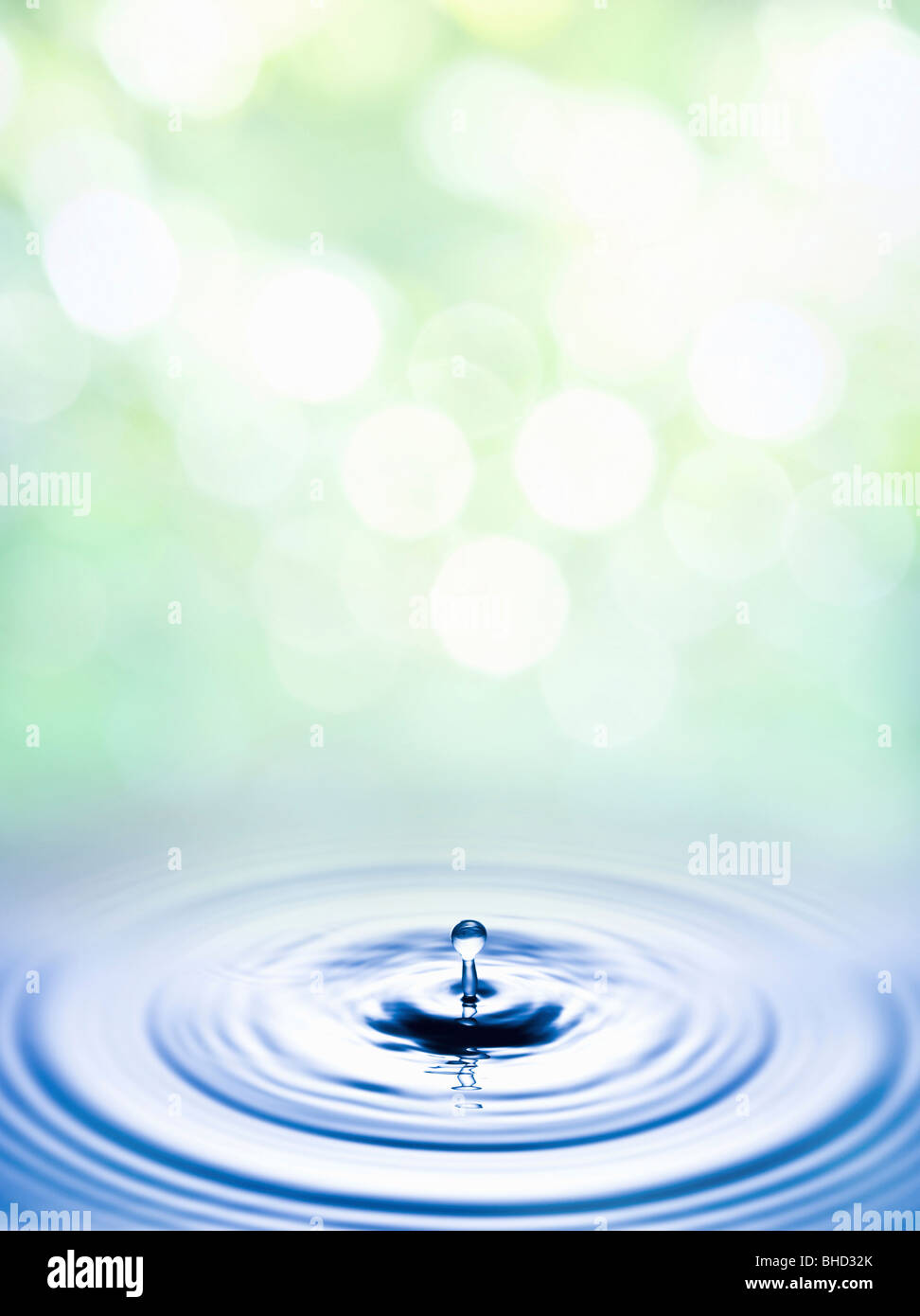 Drop creating ripples in water Stock Photo - Alamy