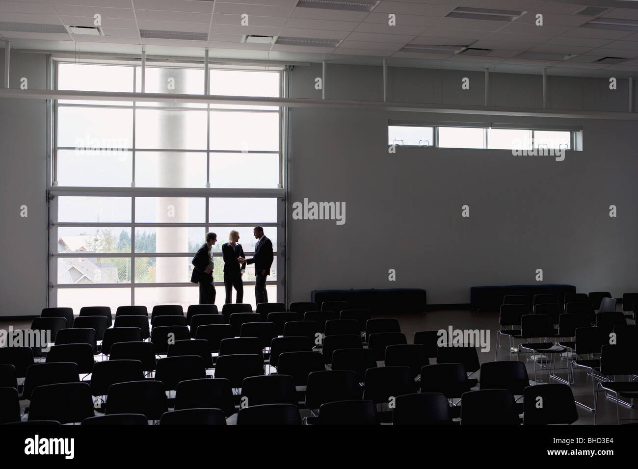 Business people talking in empty auditorium Stock Photo - Alamy