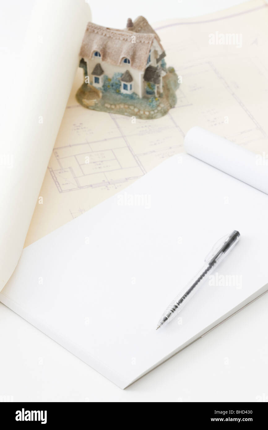 Blueprint with house ornament, notepad and pen Stock Photo - Alamy