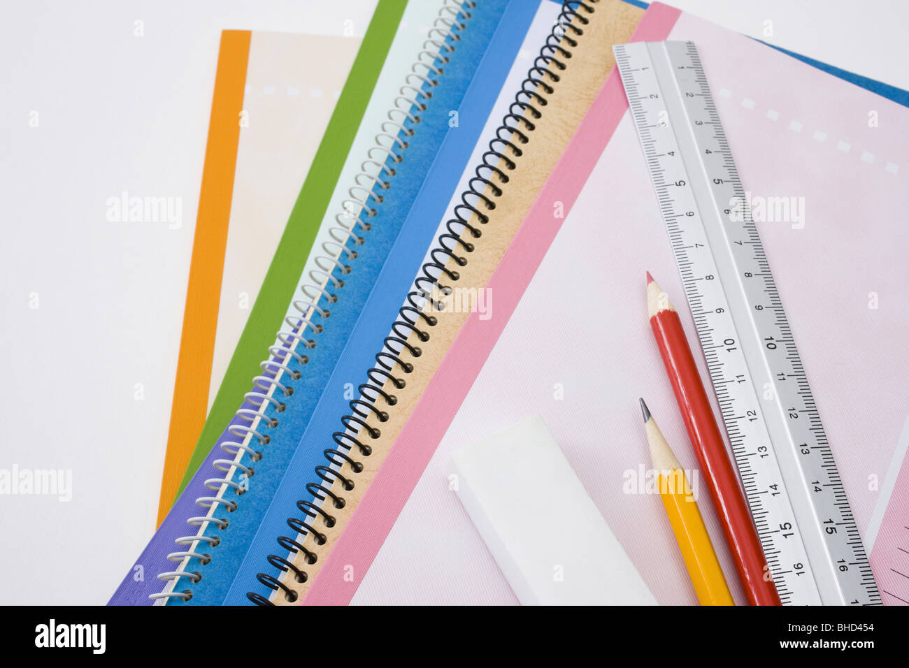 Stack of notebooks with pencils, ruler and eraser Stock Photo - Alamy