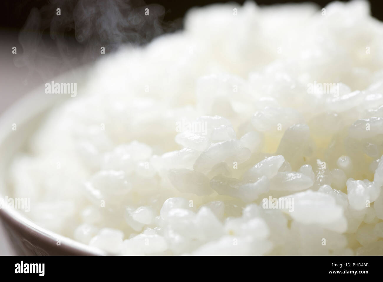 Steaming boiled rice in bowl Stock Photo - Alamy