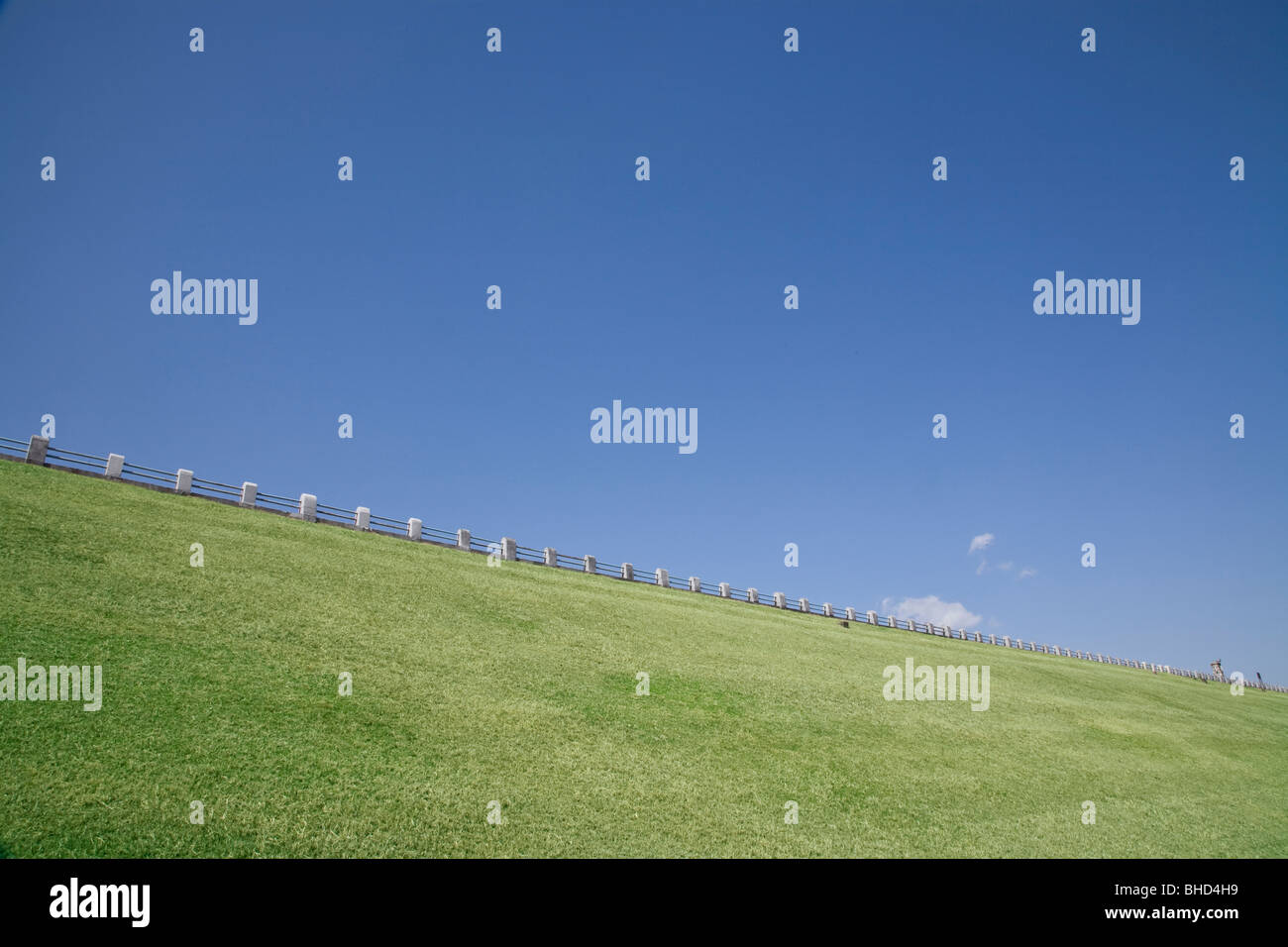 Grassy bank with fence at top, Tama, Tokyo, Japan Stock Photo - Alamy