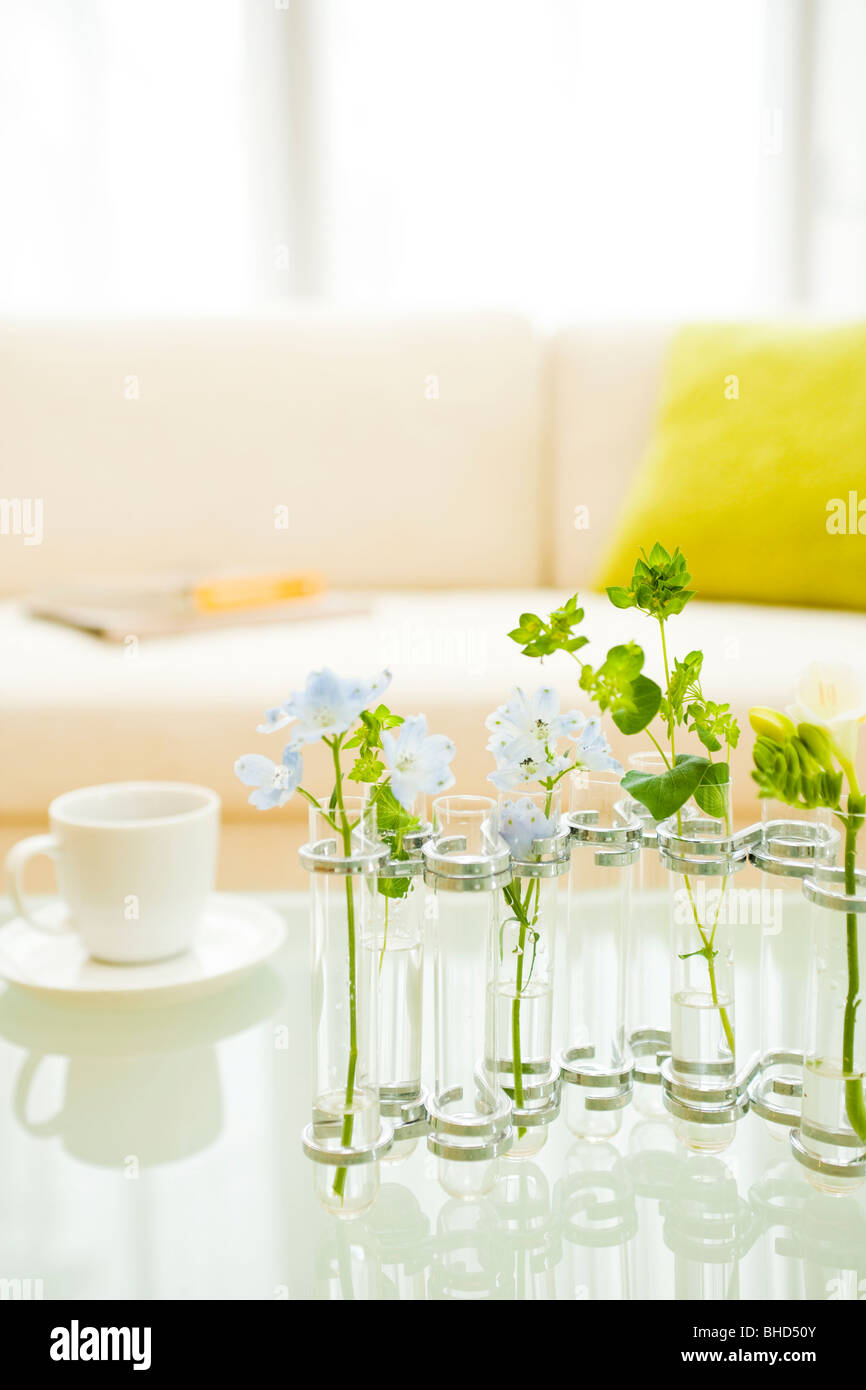Coffee table with flowers in vase and coffee cup Stock Photo - Alamy