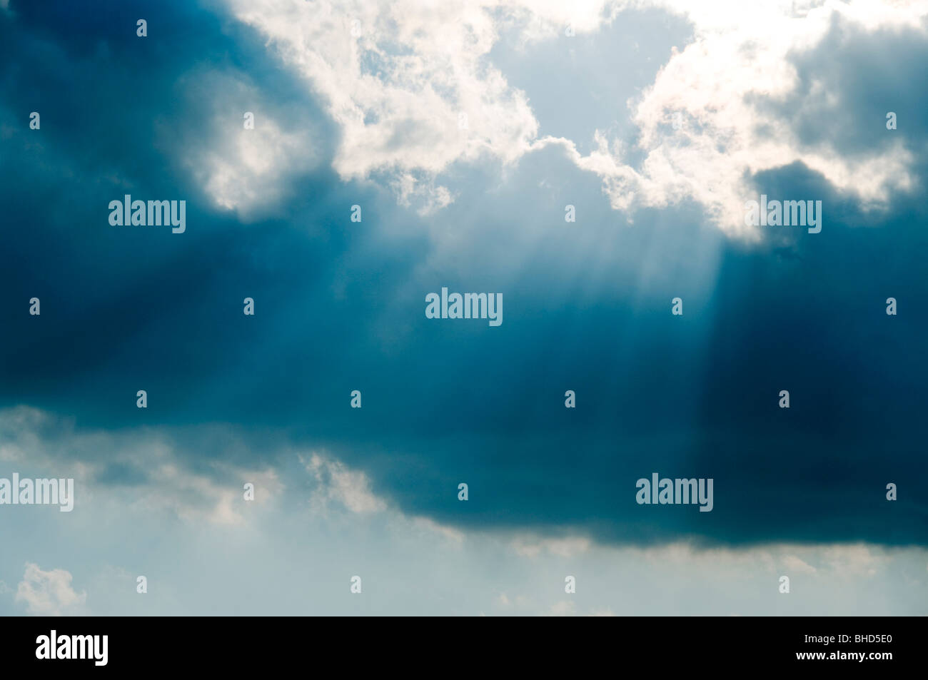 Sun shining through storm clouds Stock Photo - Alamy