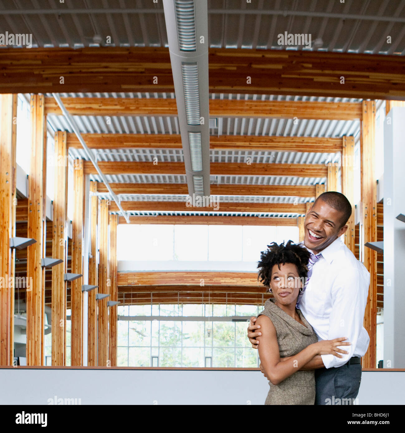 Couple laughing in empty office space Stock Photo - Alamy