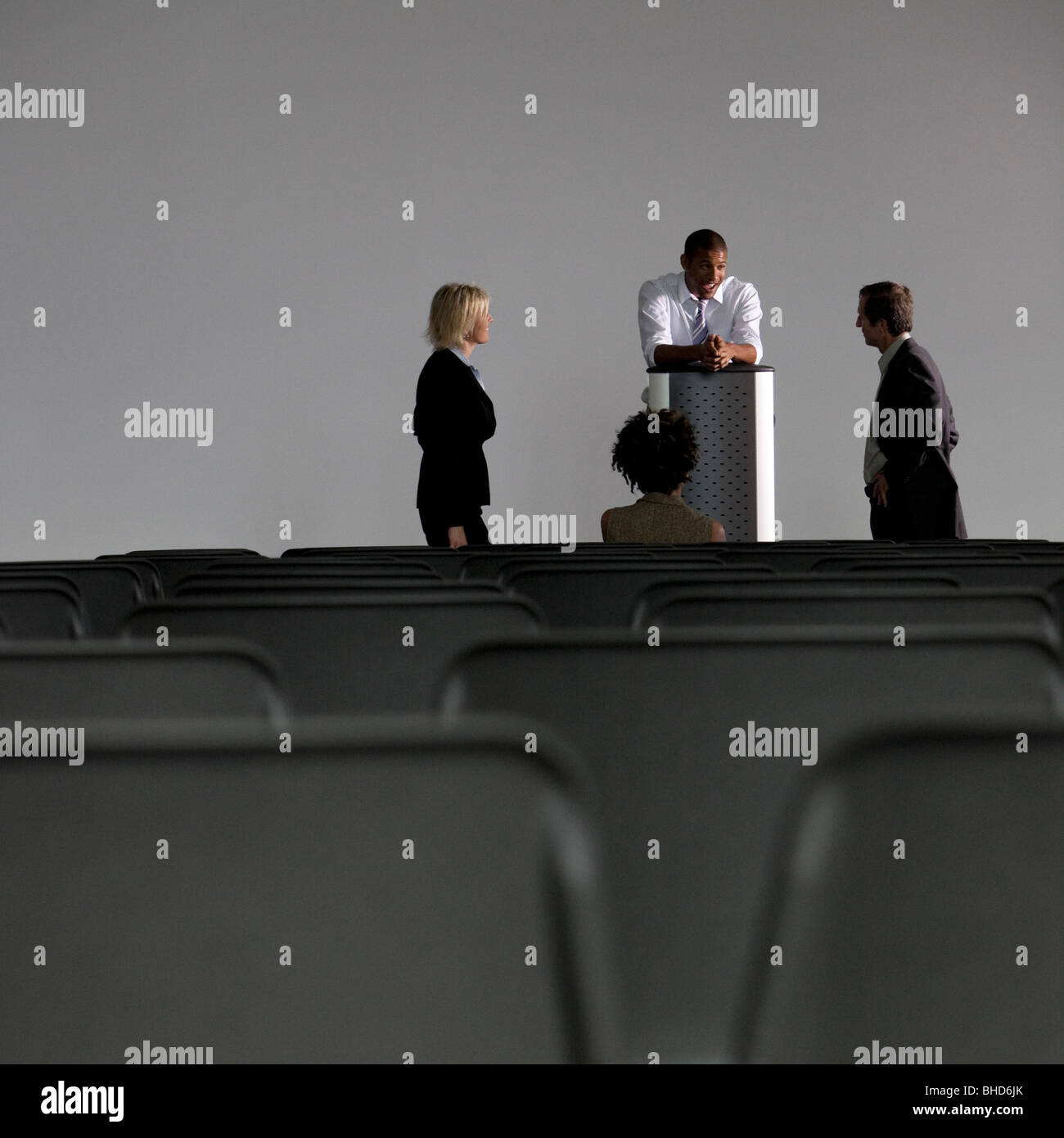 Business people talking in empty auditorium Stock Photo - Alamy
