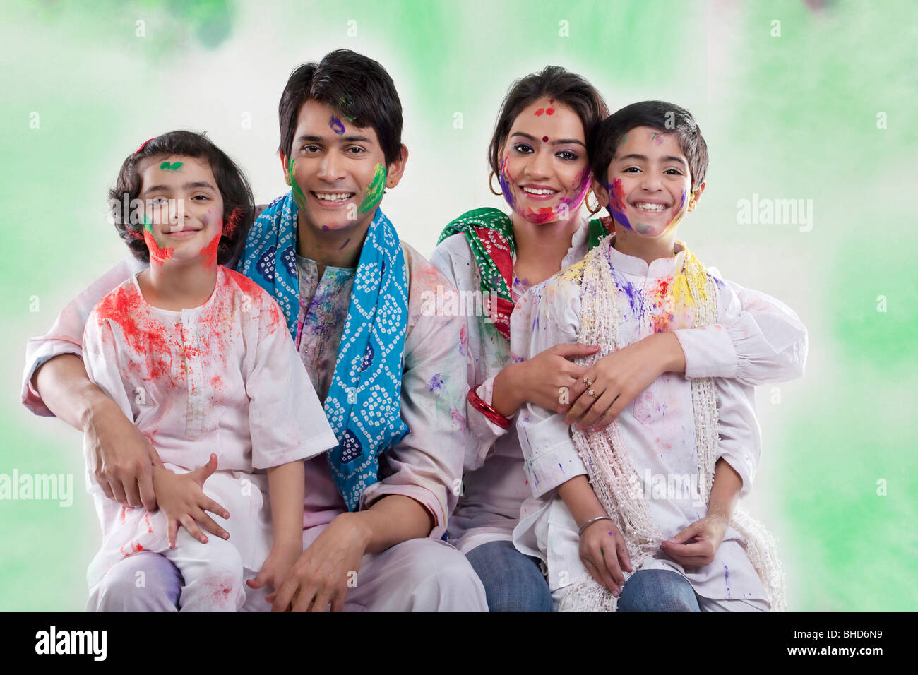 Family posing after playing holi Stock Photo - Alamy