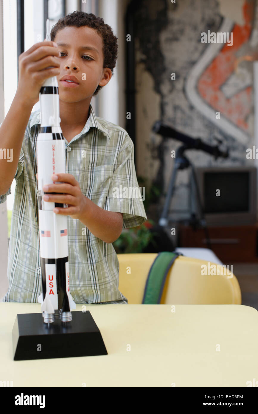 Mixed race boy building model rocket Stock Photo - Alamy