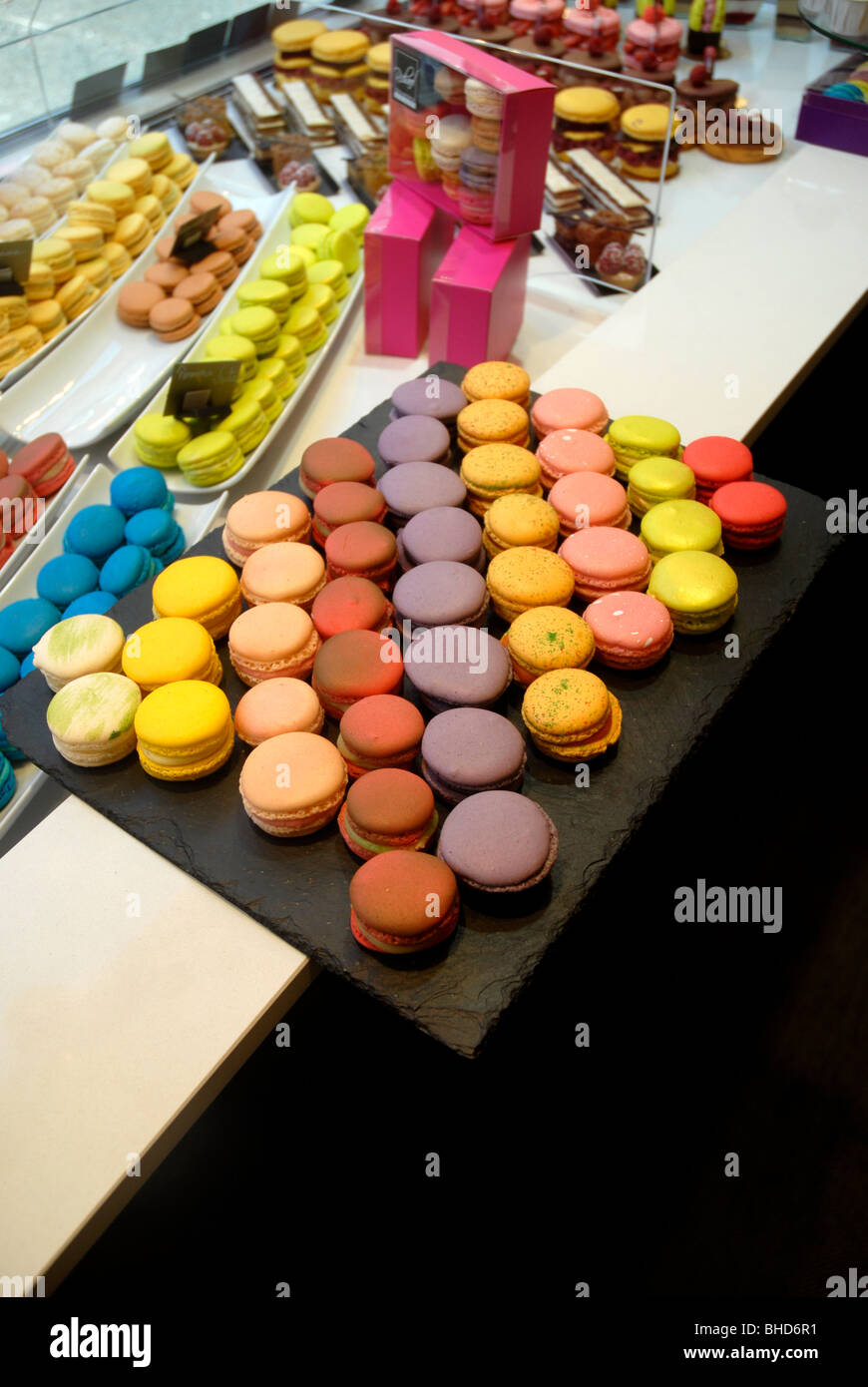 Multi colored Macaroons on display in shop window Stock Photo - Alamy
