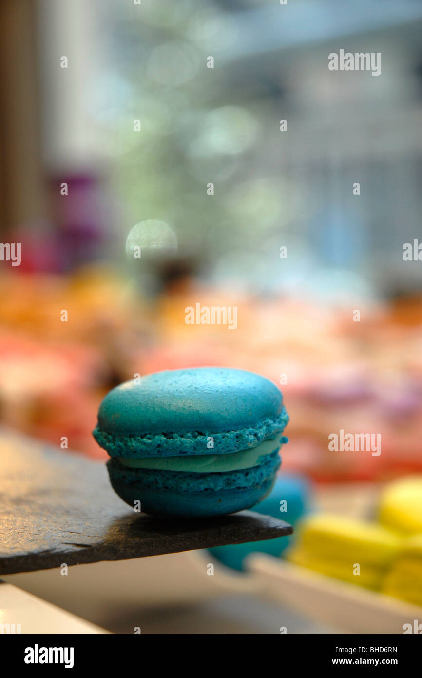 Multi colored Macaroons on display in shop window Stock Photo - Alamy