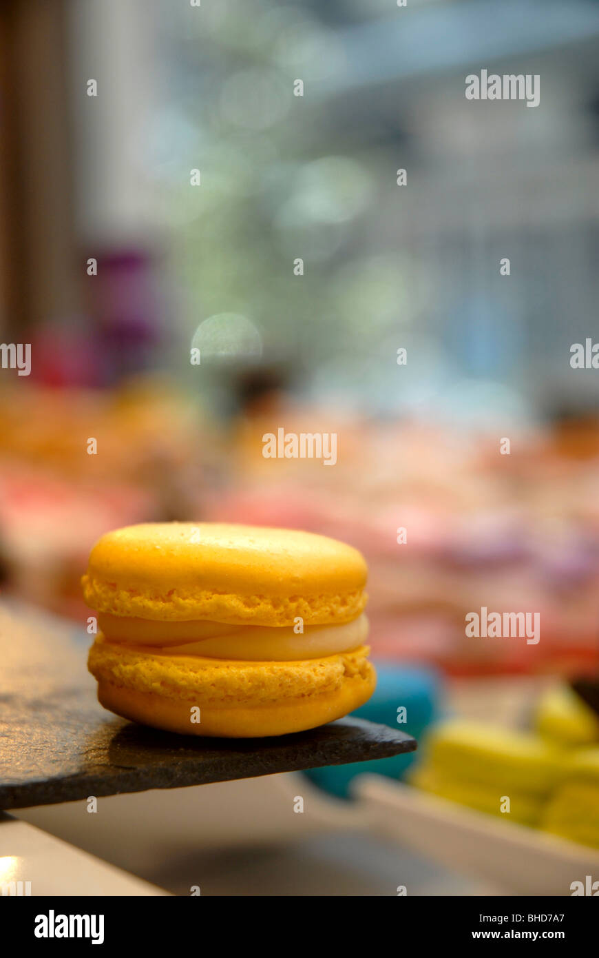 Multi colored Macaroons on display in shop window Stock Photo - Alamy